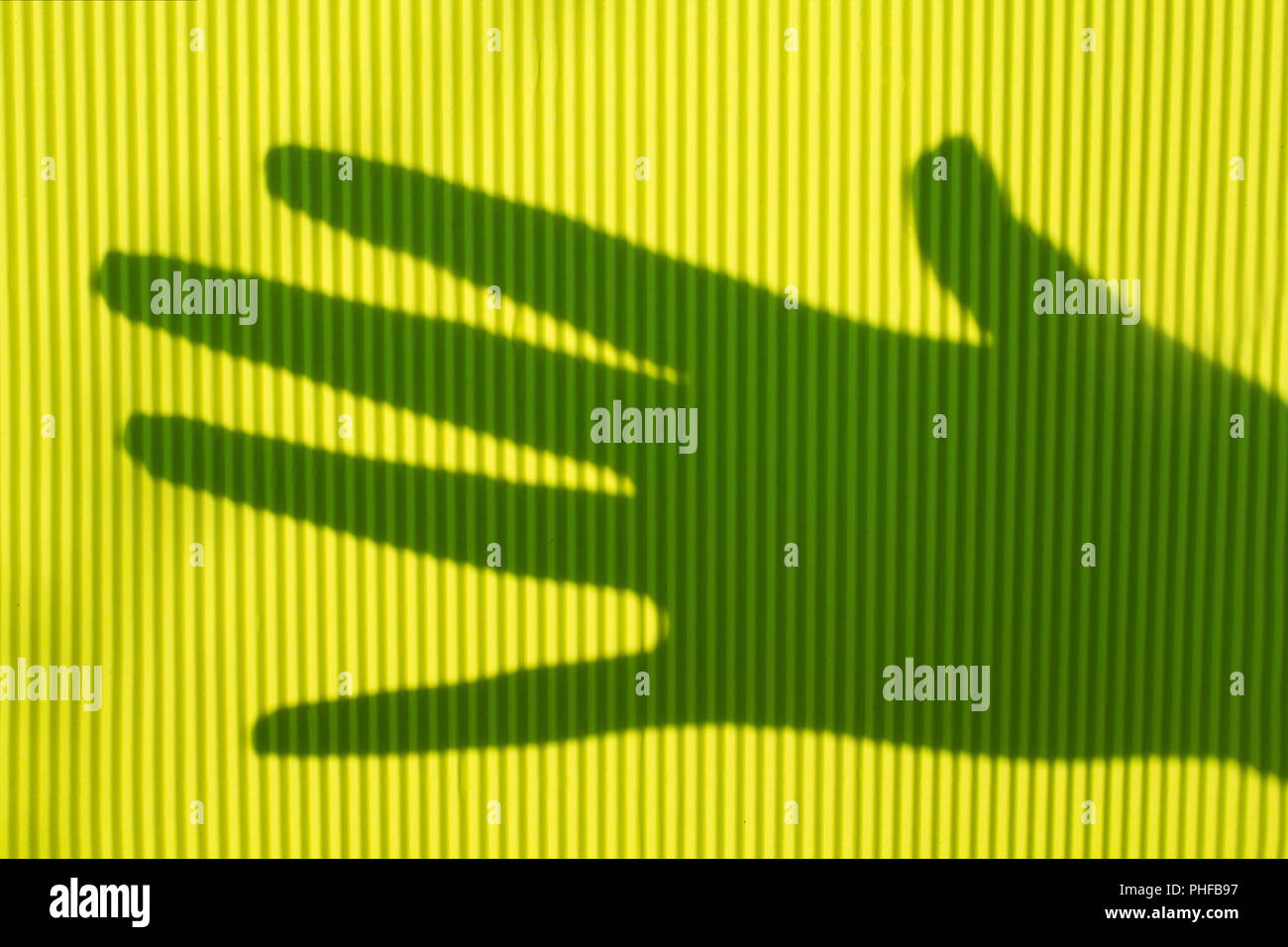 SHADE HANDS ON THE YELLOW BACKGROUND Stock Photo - Alamy