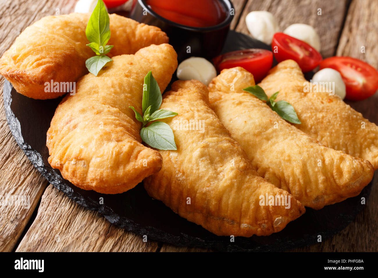 Italian pastries: deep-fried panzerotto with tomato sauce and ...