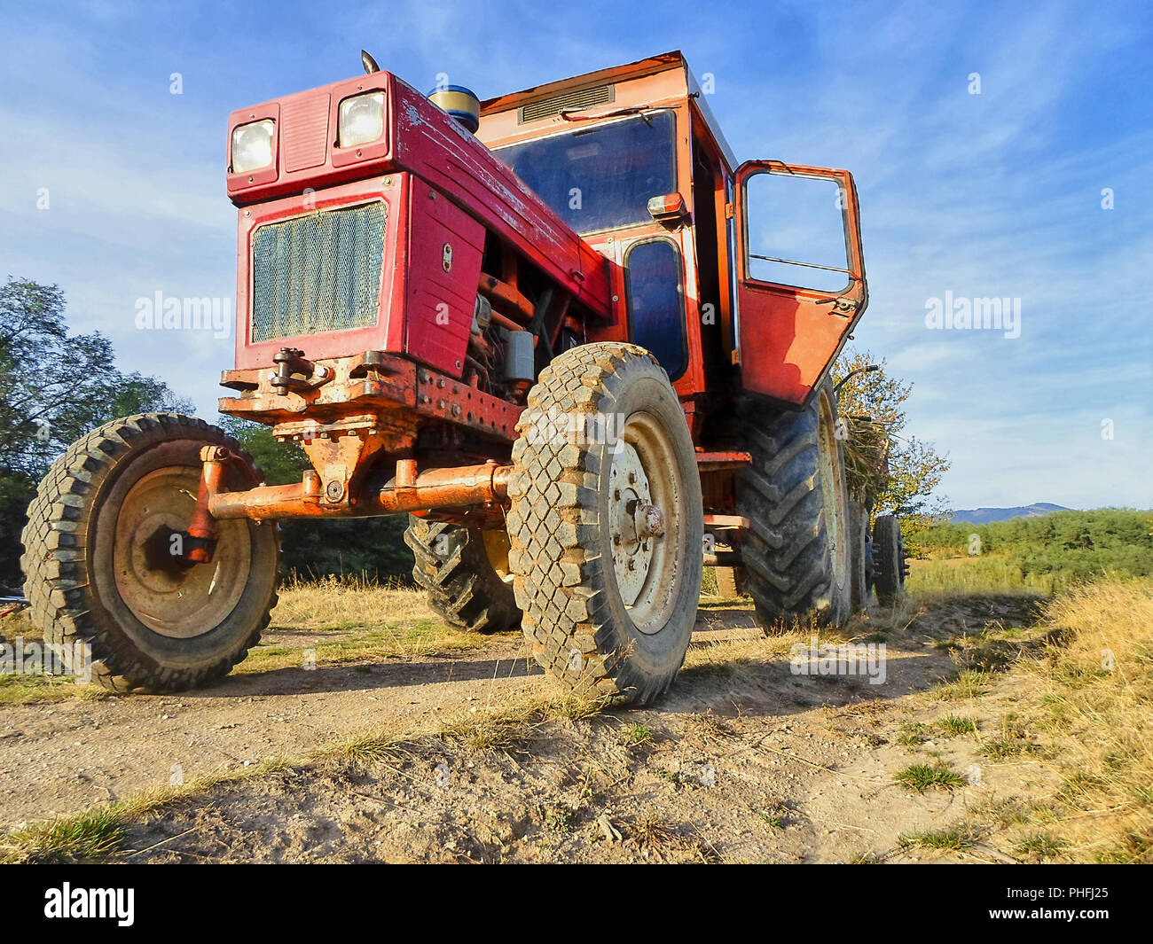 Red tractor in woods hi-res stock photography and images - Alamy