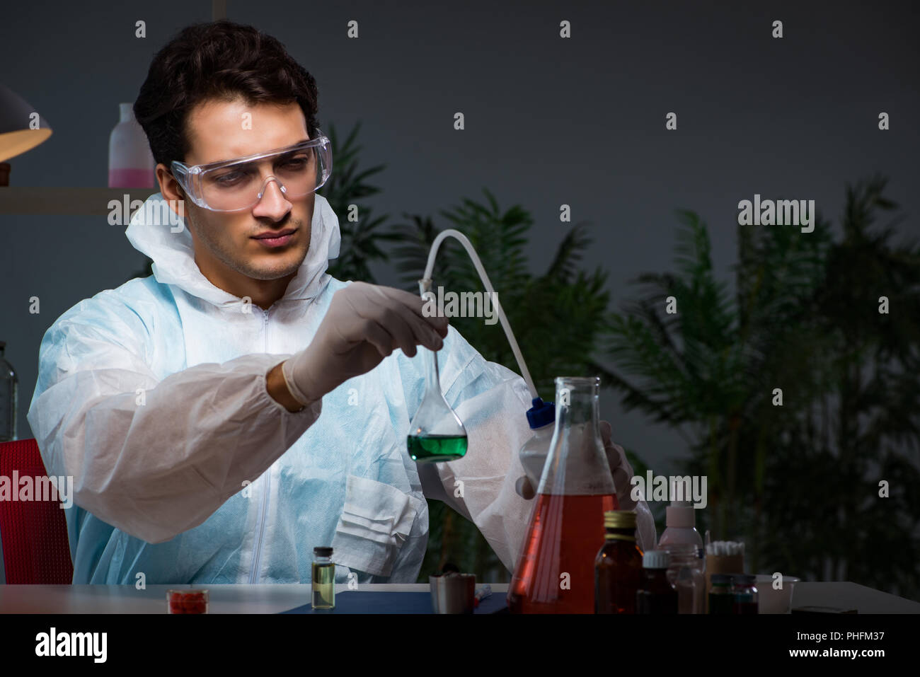 Young male lab chemist late at night in overtime time Stock Photo - Alamy