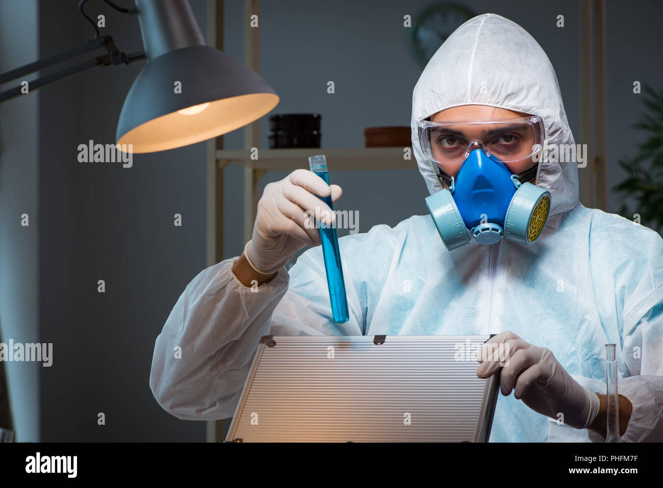 Forensic investigator working in lab looking for evidence Stock Photo ...