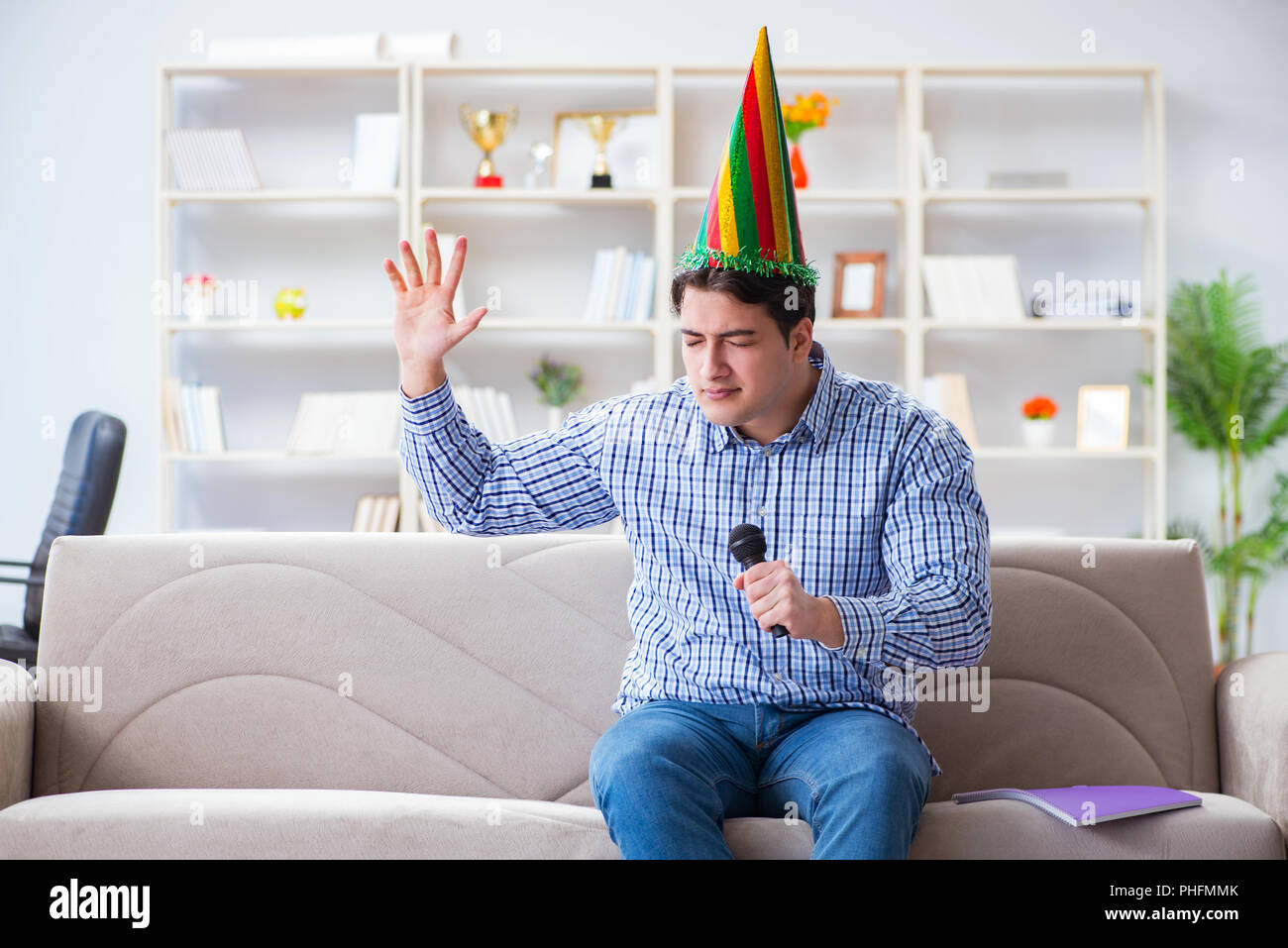 Funny man singing songs in karaoke at home Stock Photo - Alamy