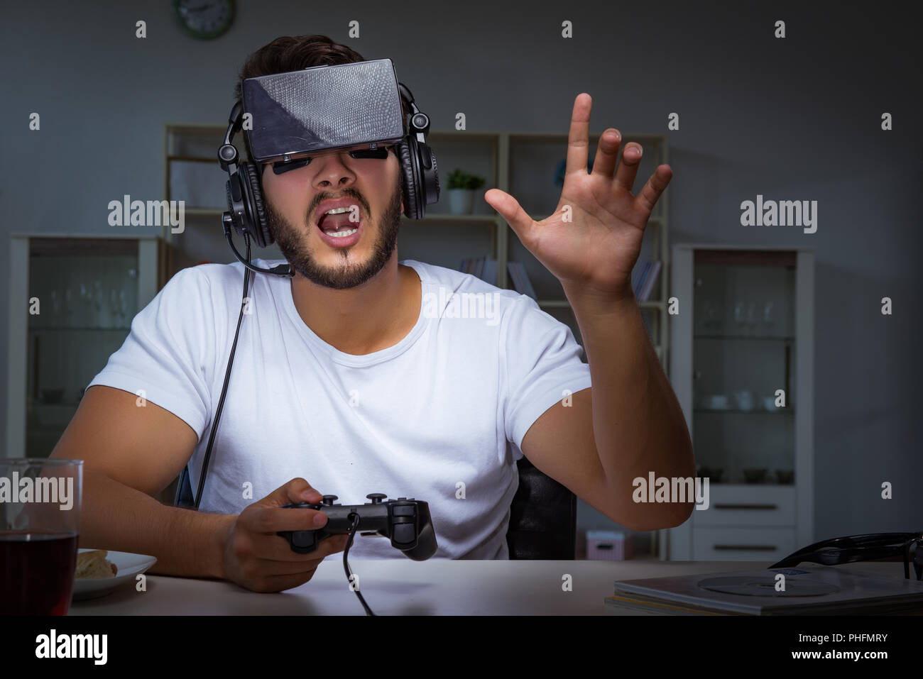 Young man playing games long hours late in the office Stock Photo - Alamy