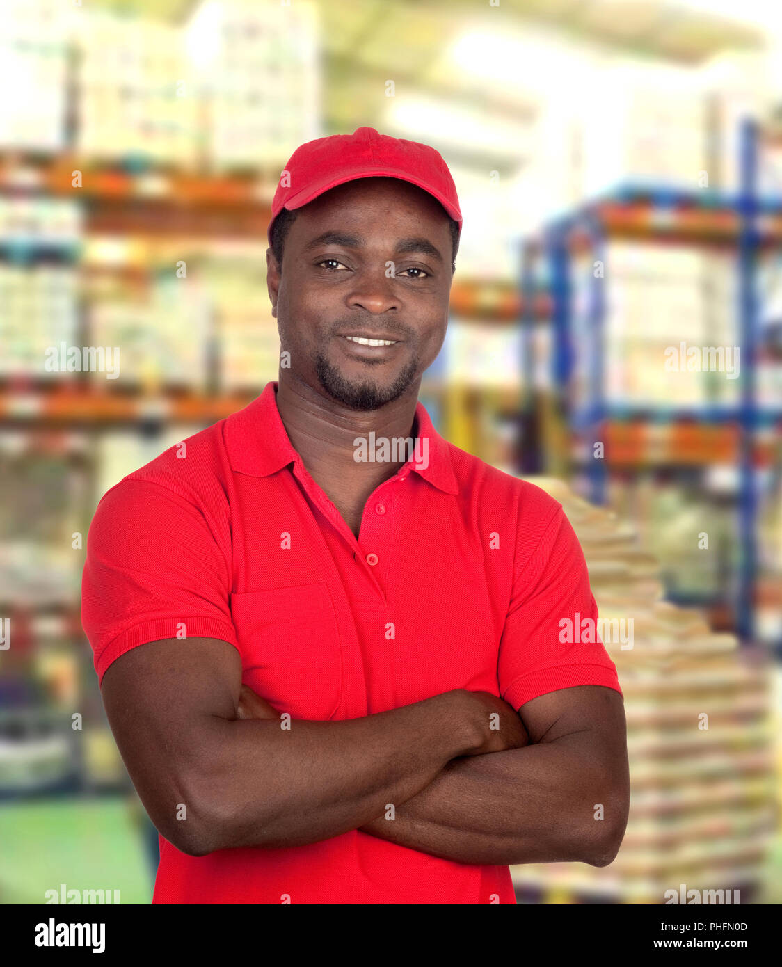 Handsome african man working at logistics warehouse Stock Photo - Alamy