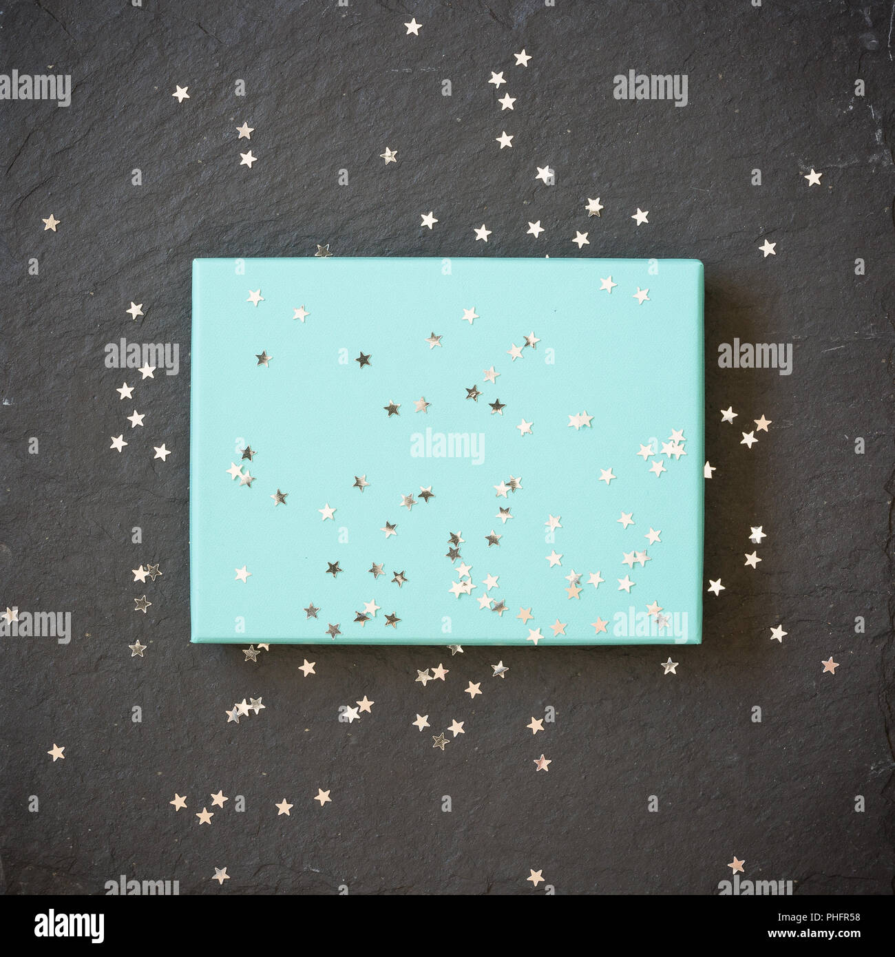 rectangular light blue box on black background with silver stars ...