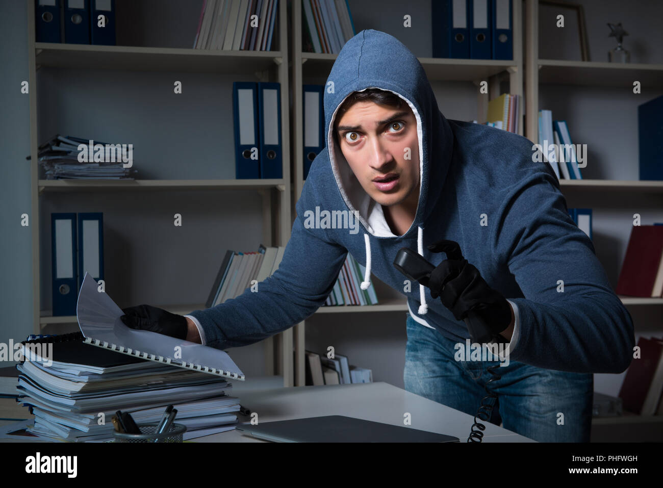 Young man in industrial espionage concept Stock Photo - Alamy