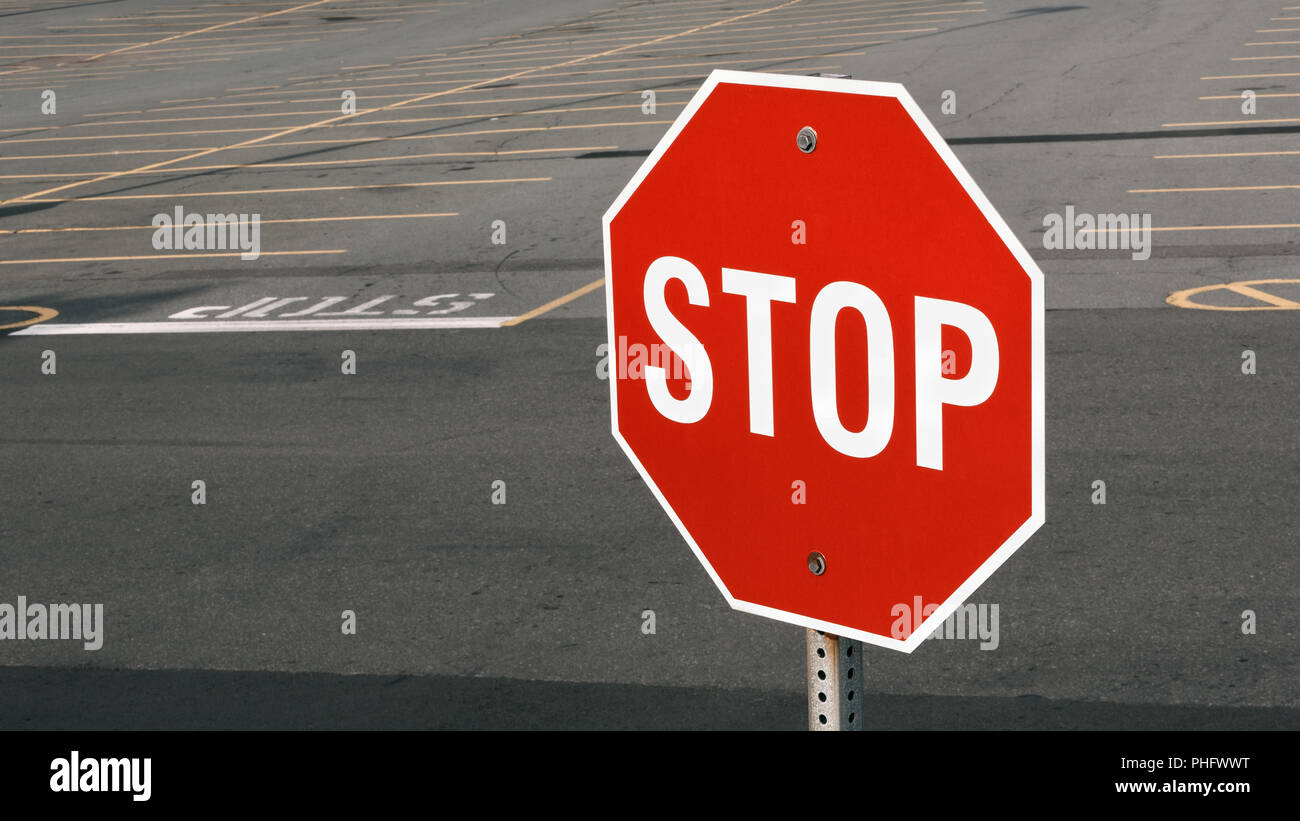 Stop sign in front of parking lot. Wide format Stock Photo - Alamy