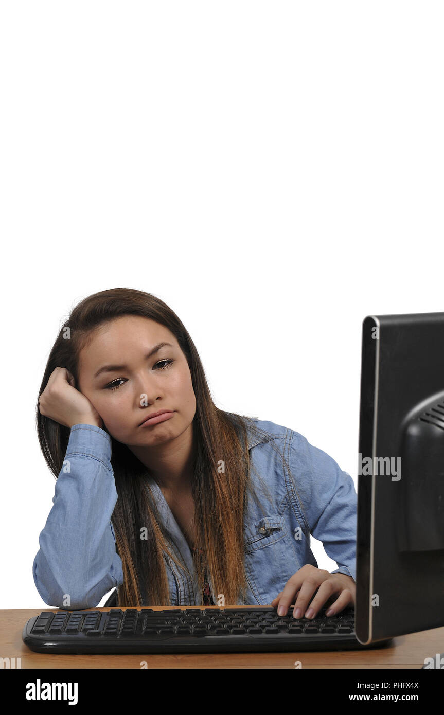 Teenage girl doing homework on a computer Stock Photo - Alamy