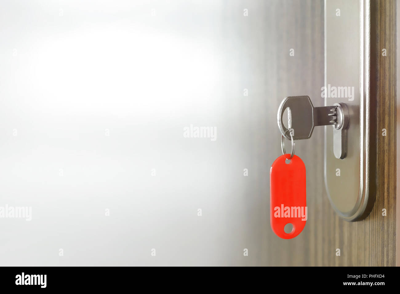 House key in door copyspace Stock Photo - Alamy