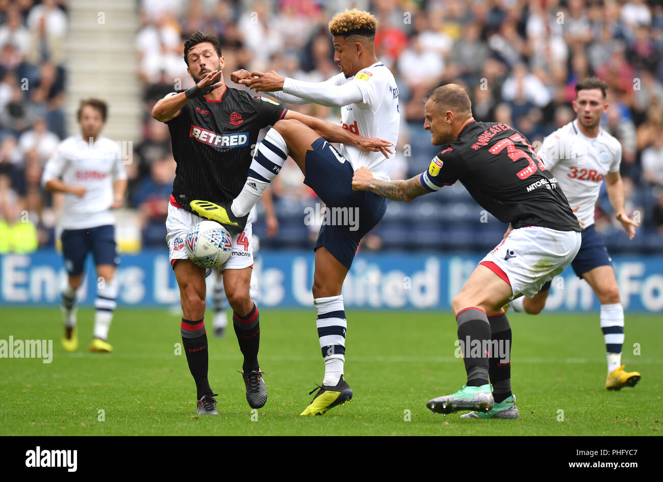 Preston North End's Callum Robinson competes for possession with Bolton ...