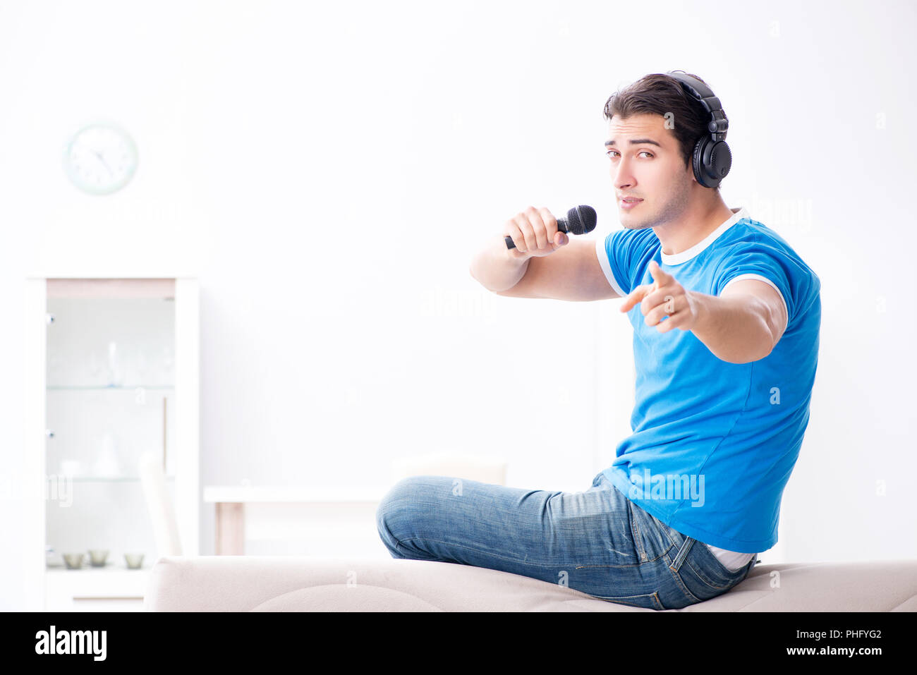 Young man singing at home karaoke Stock Photo - Alamy