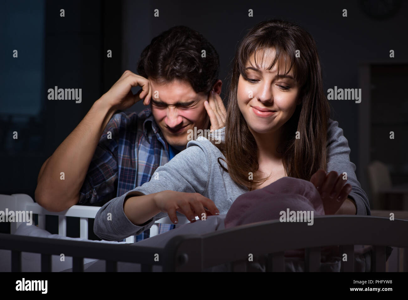Young parents sleepless with newborn baby at night Stock Photo - Alamy