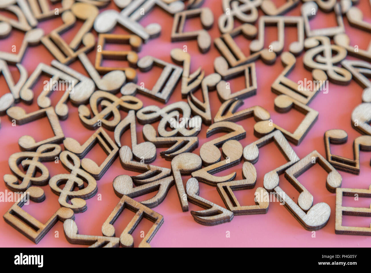background of music. background of music. Wooden notes on a pink ...