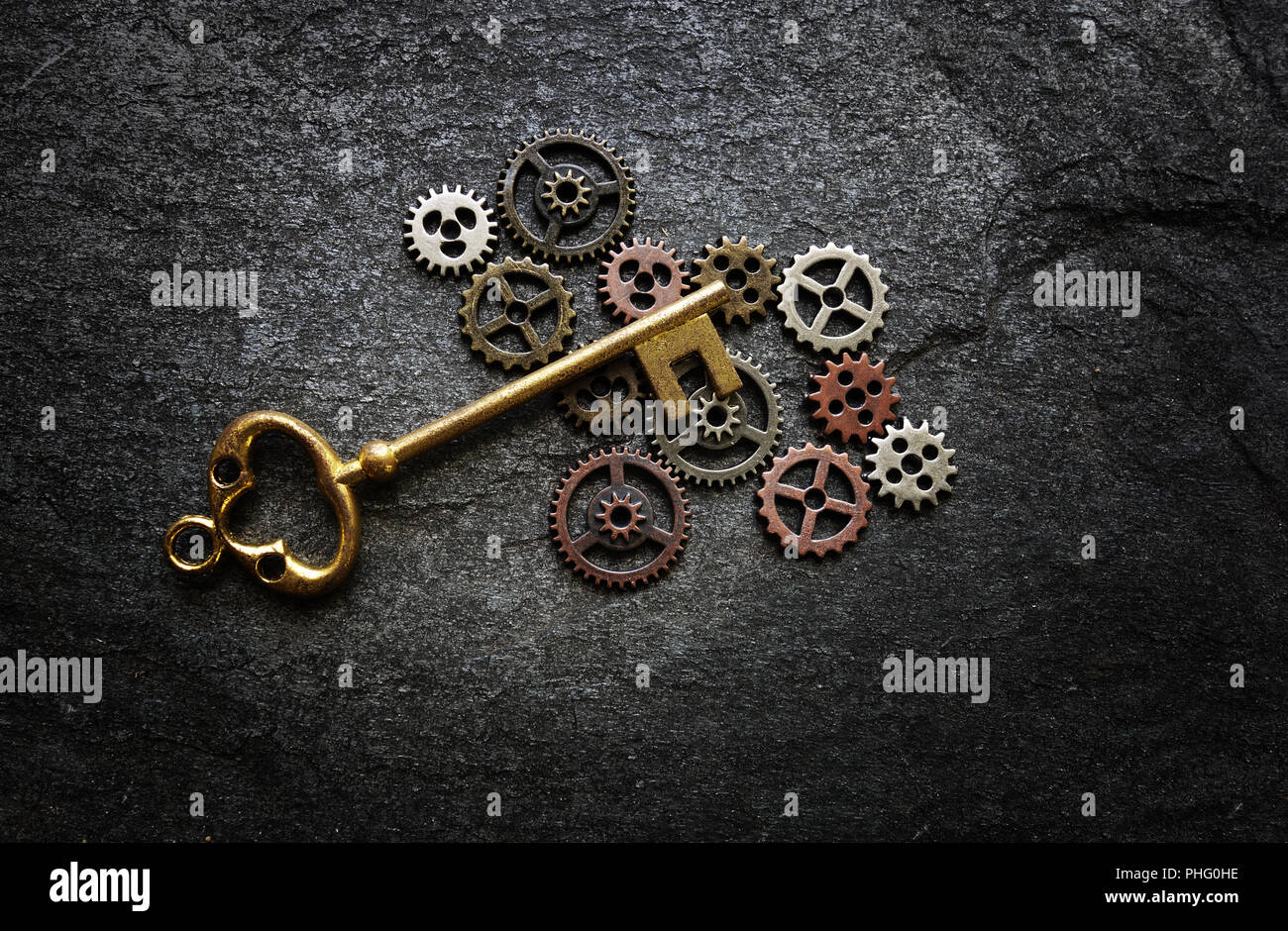 Gears and antique key Stock Photo - Alamy