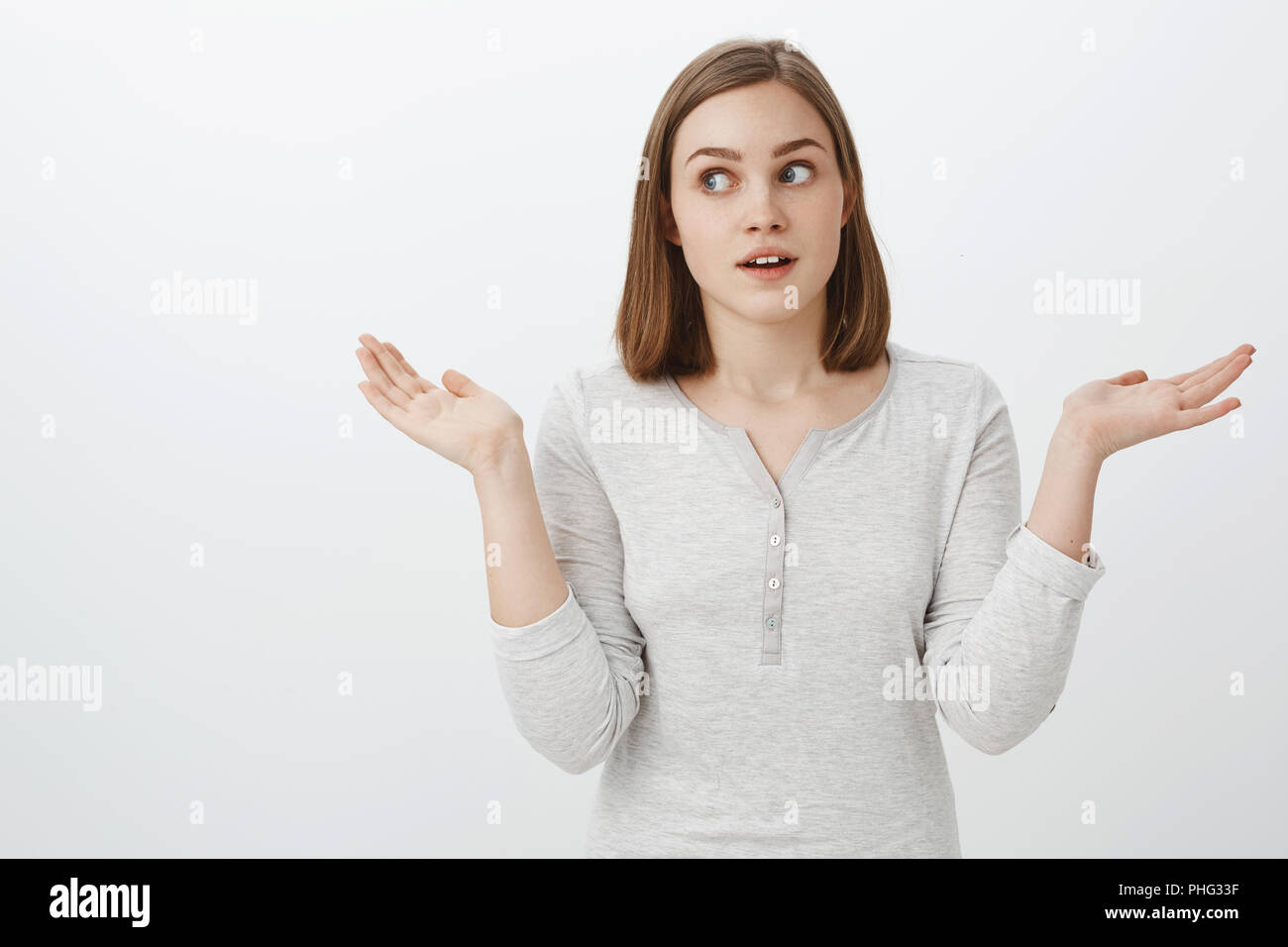 Girl acting clueless in front of parents. Portrait of cute emotive ...