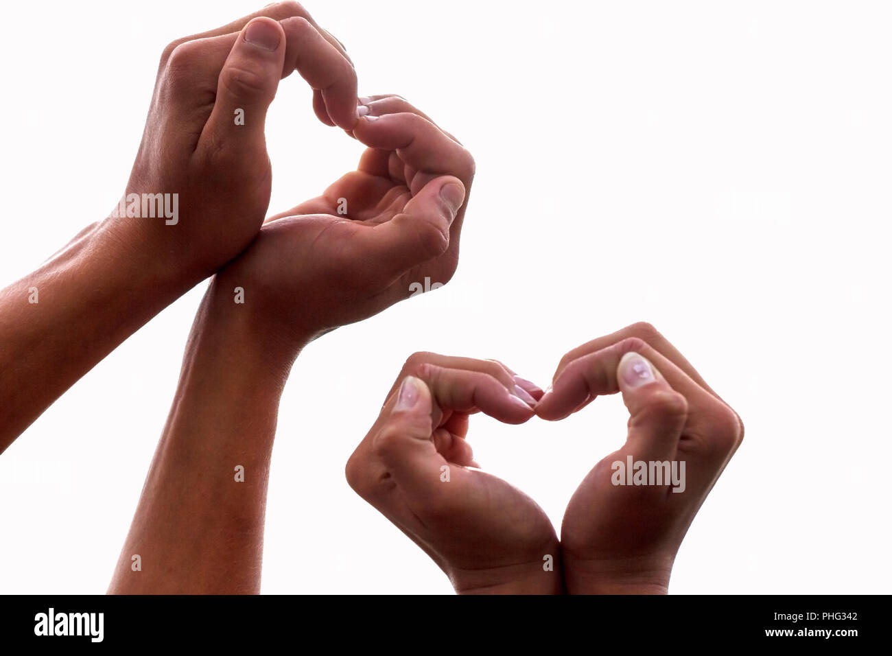 People making hearts with their hands hi-res stock photography and ...