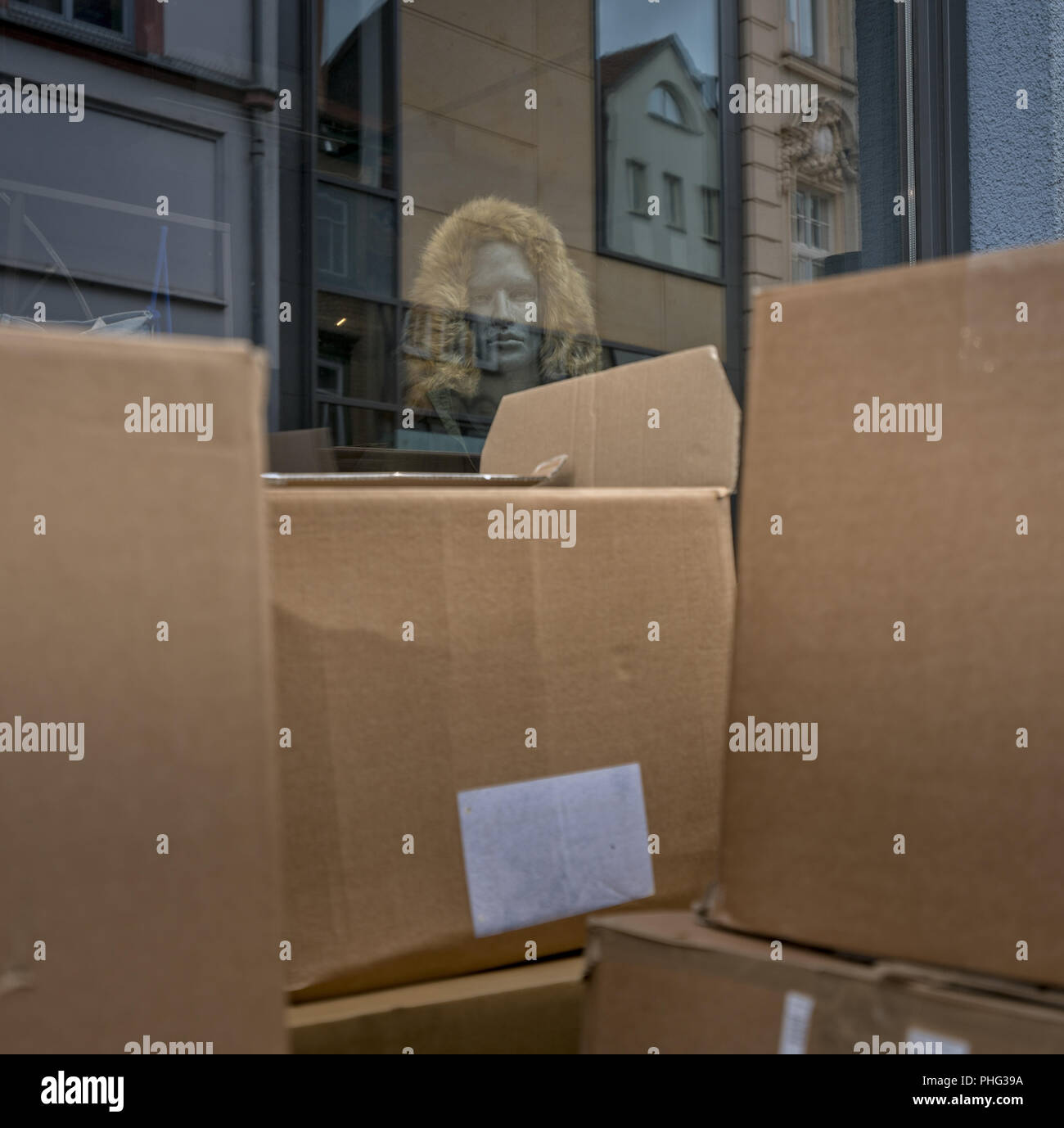 Cardboard boxes stand in front of a shop window Stock Photo - Alamy