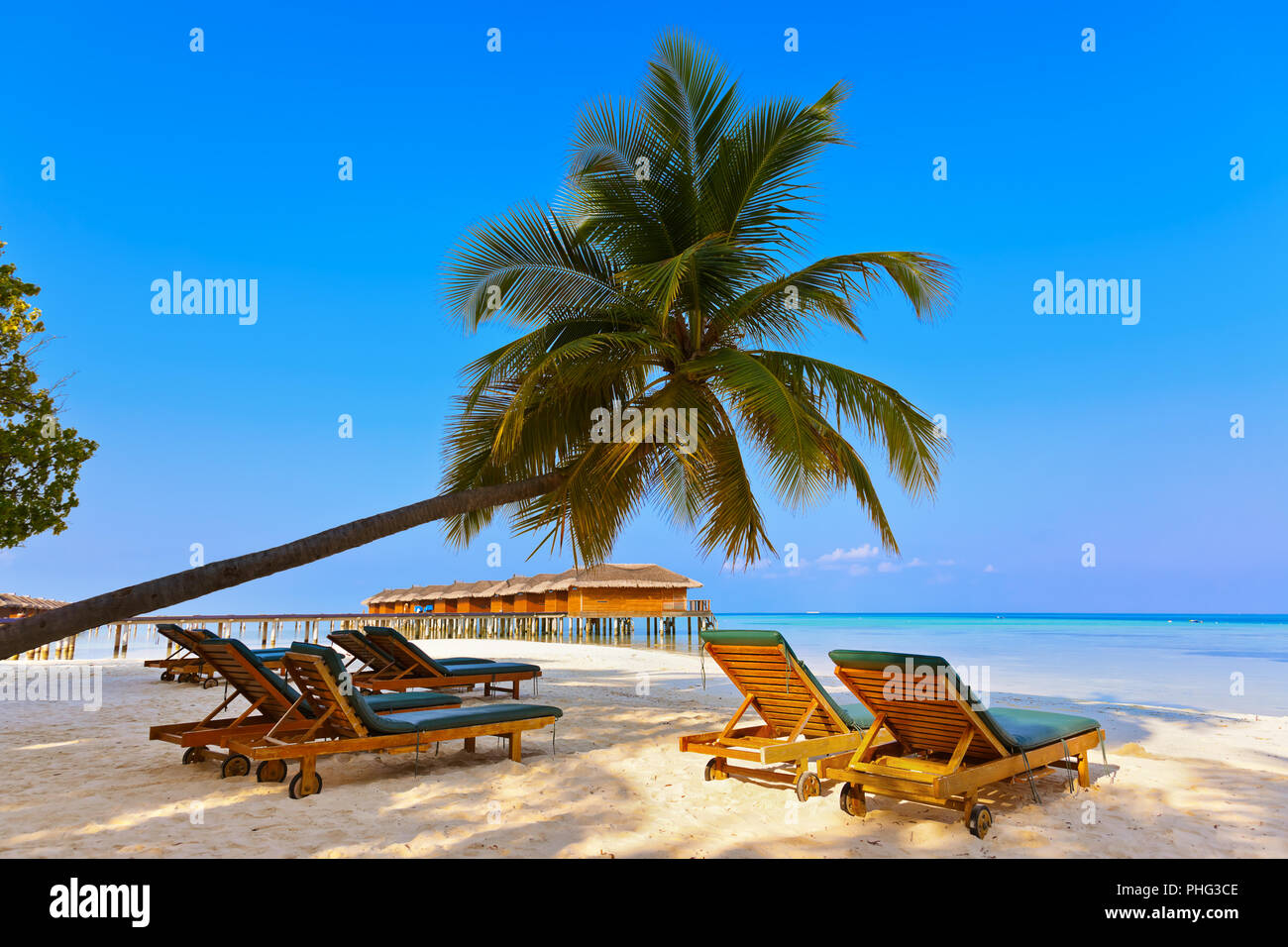 Loungers on Maldives beach Stock Photo - Alamy