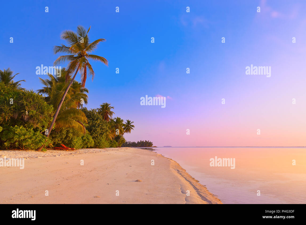 Sunset in Maldives beach Stock Photo - Alamy