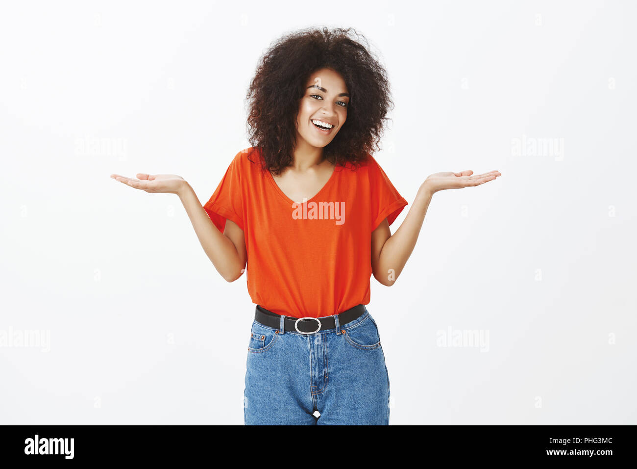 Indoor shot of happy carefree good-looking woman with afro hairstyle in ...