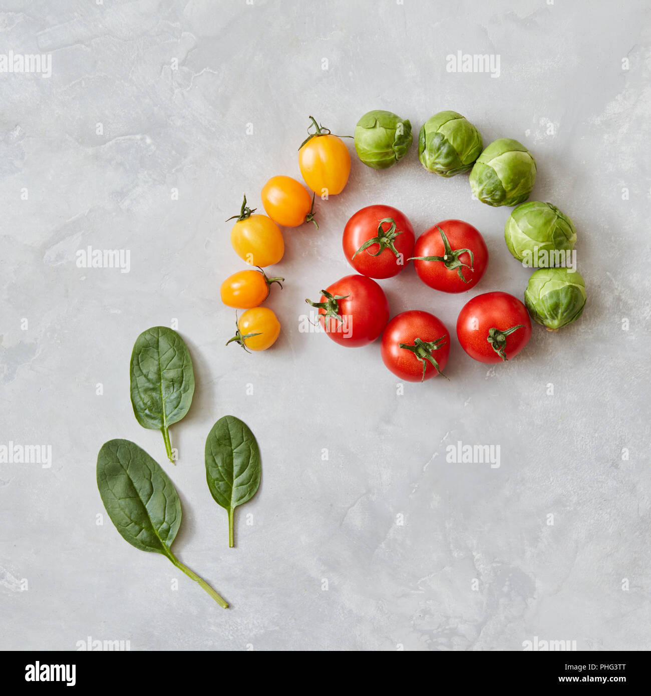 Composition of tomatoes and spinach leaves Stock Photo - Alamy