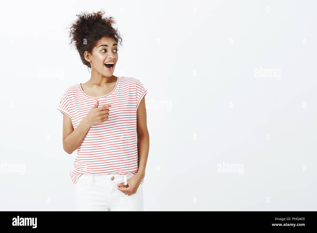 Portrait of impressed happy attractive female student with combed curly ...
