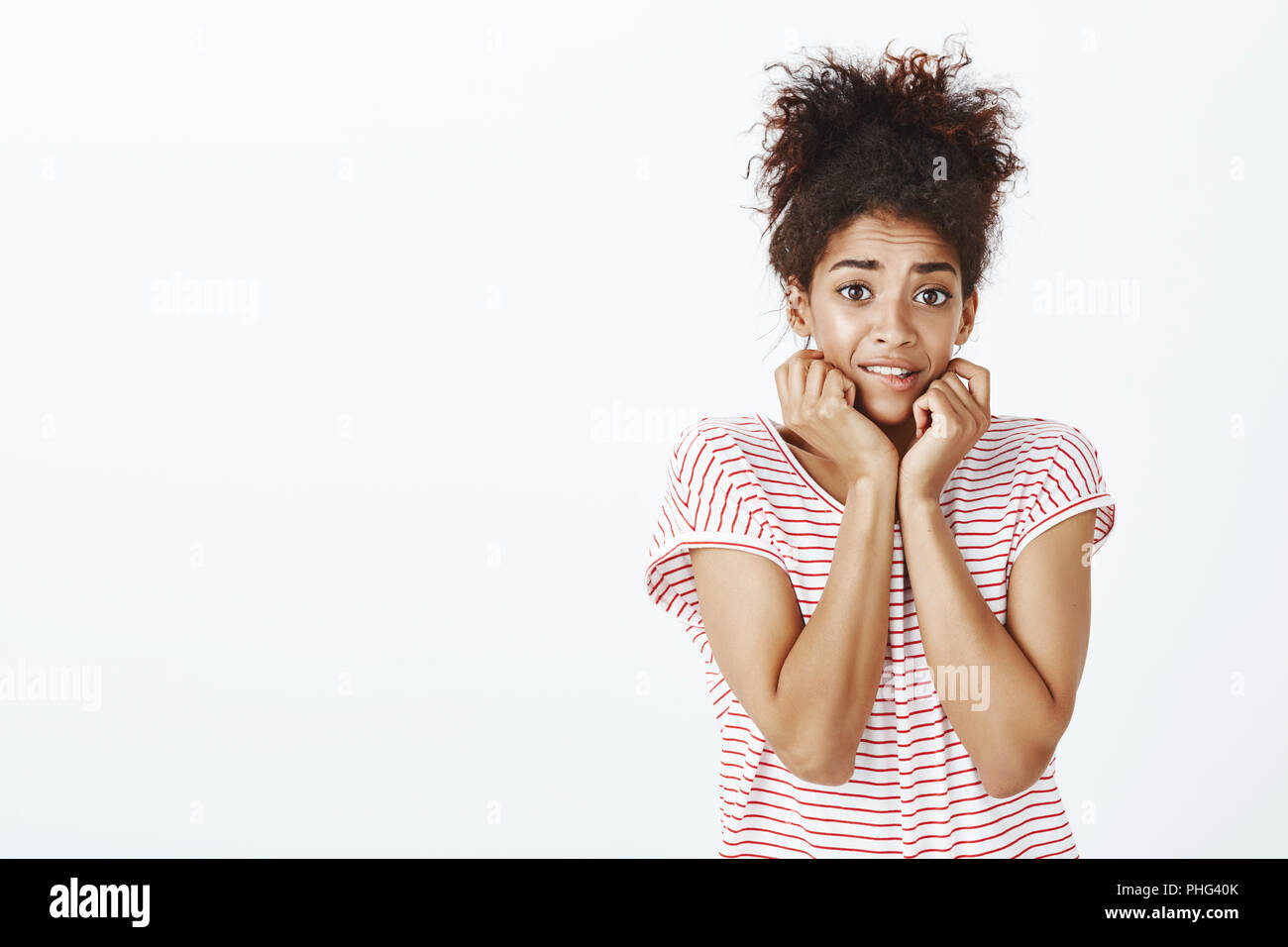 Indoor shot of timid insecure attractive tanned woman with curly hair ...