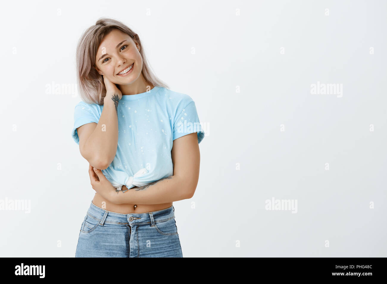 Indoor shot of feminine charming woman in stylish clothes, tilting head ...