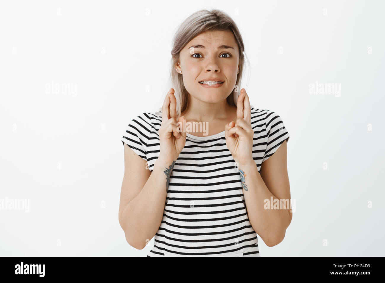 Hope everything will be fine. Worried good-looking woman in striped t ...