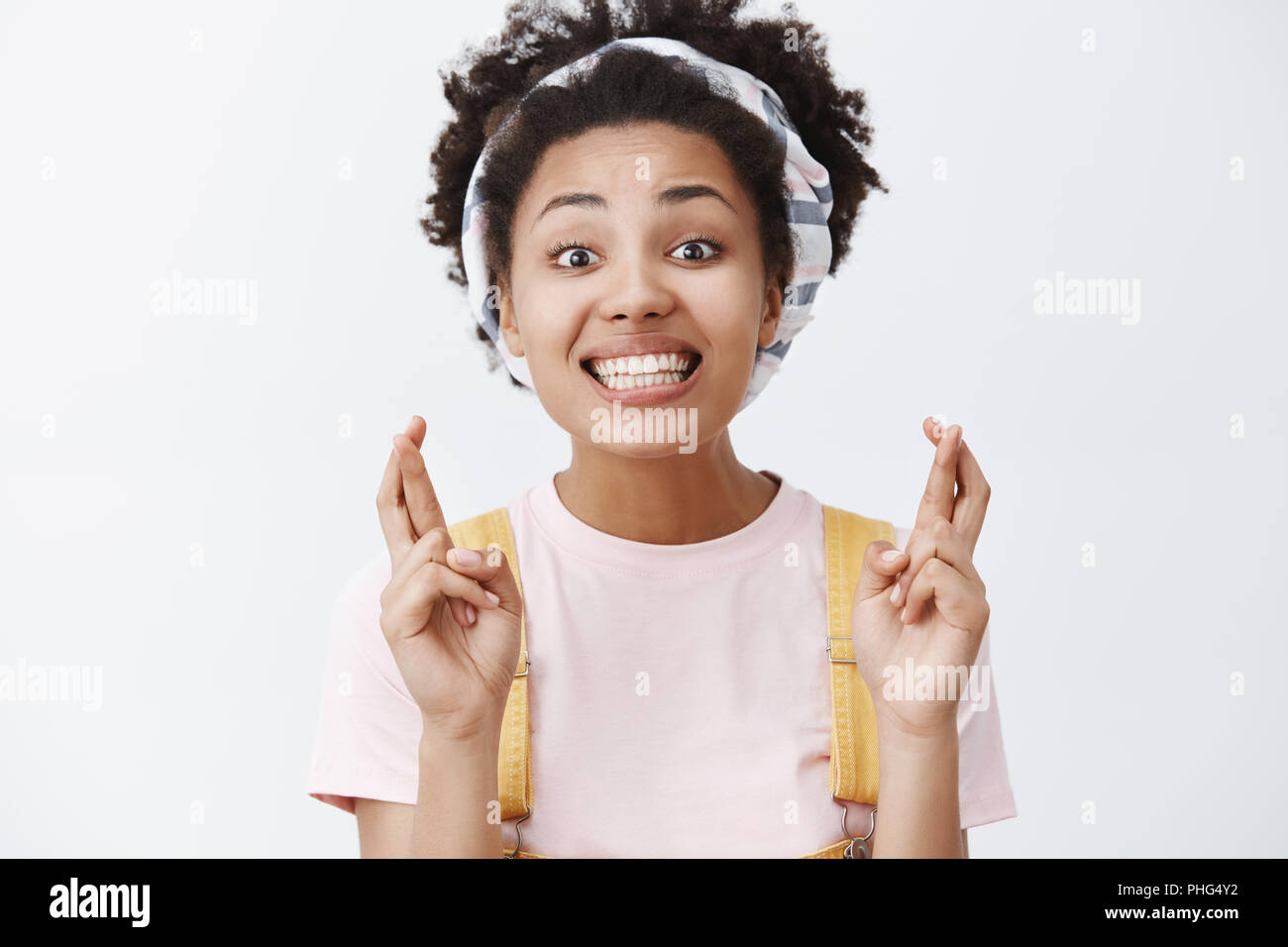 Emotional female keeping fingers hi-res stock photography and images ...