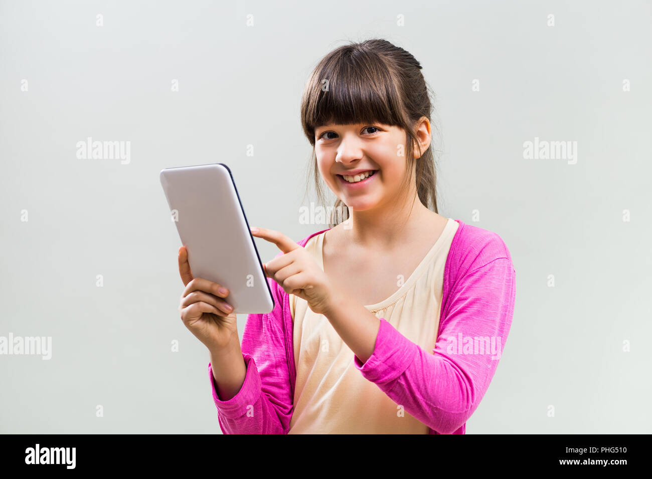 Little girl using digital tablet Stock Photo - Alamy