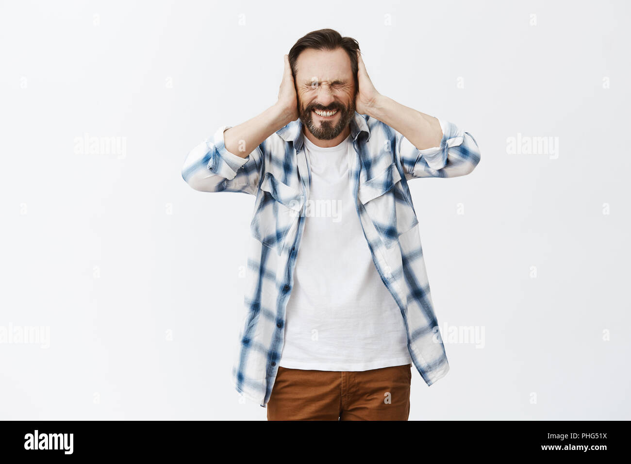 Man suffering from loud voices in head, being displeased and miserable ...
