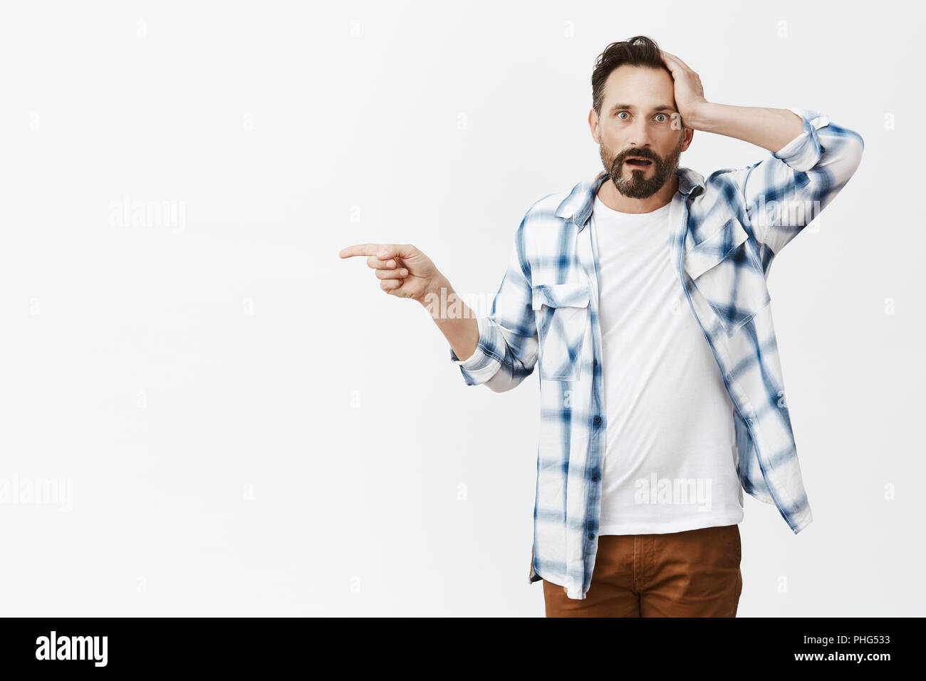 What was that. Confused and puzzled handsome caucasian man holding hand ...