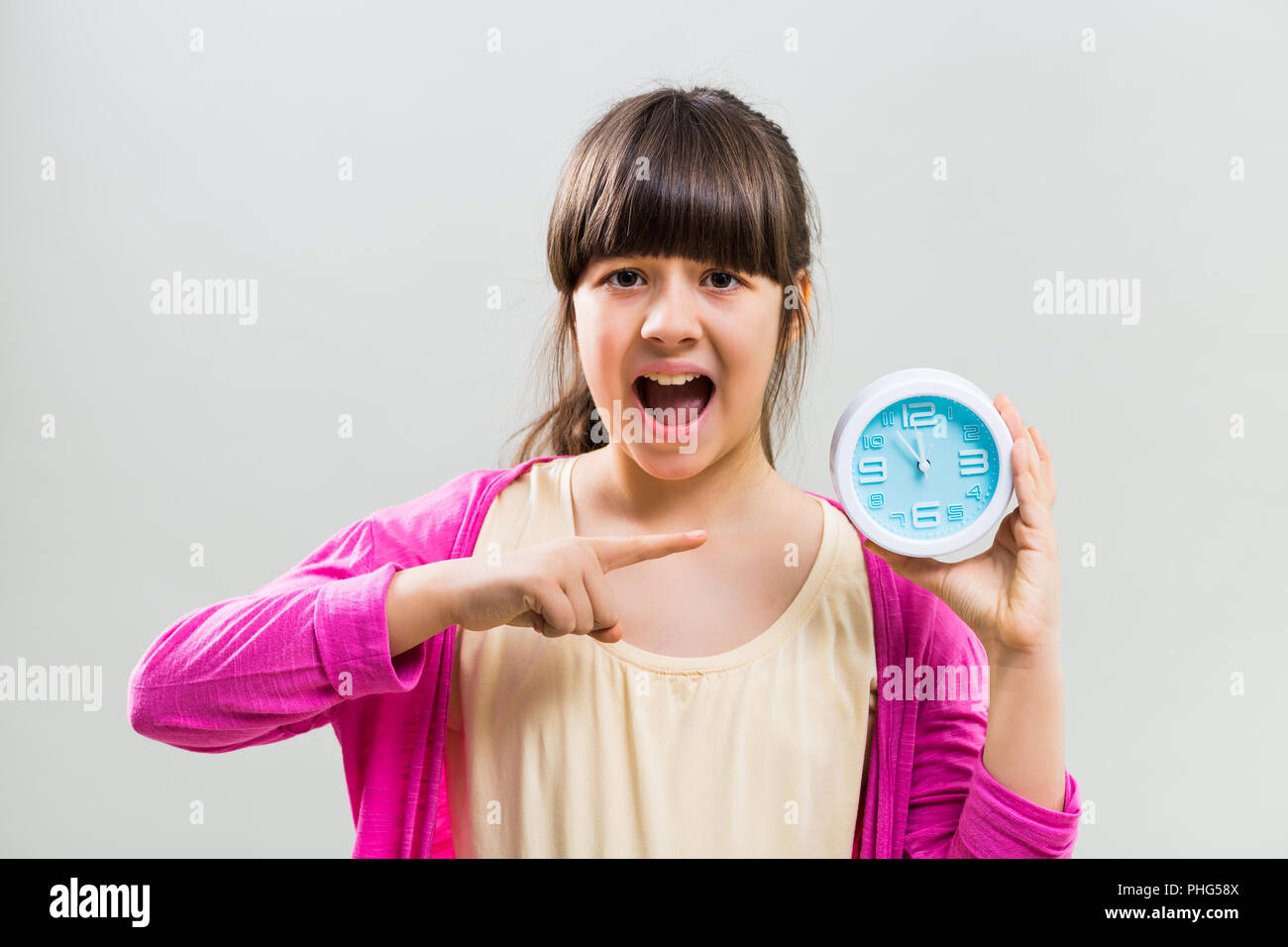 Little girl in panic pointing at clock Stock Photo - Alamy