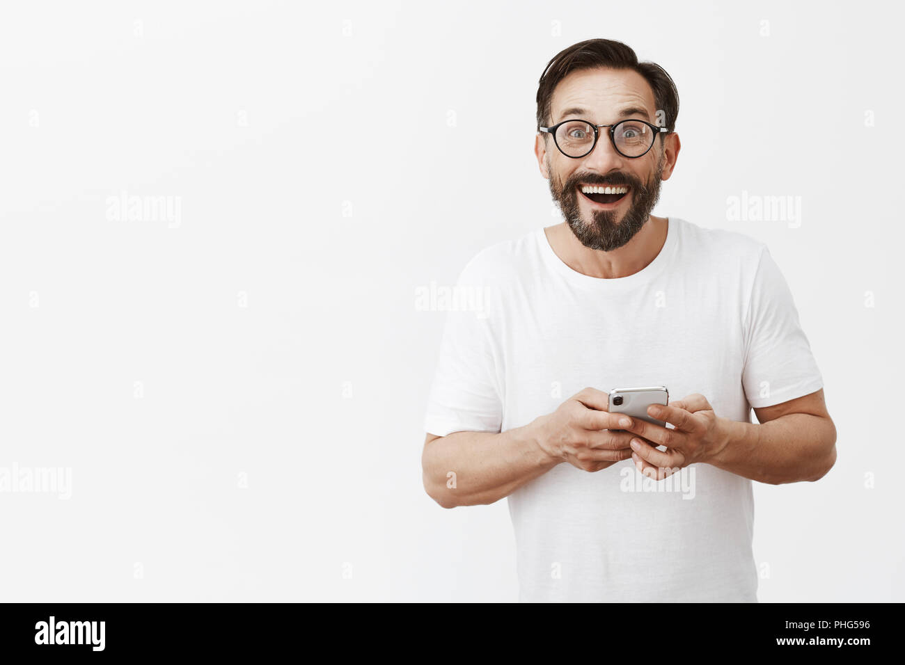 Man happy to gain maximum score in new app. Portrait of pleased joyful ...