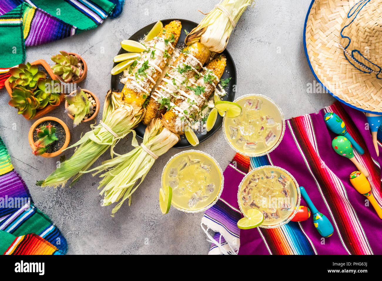 Top view. Grilling mexican street corn elote garnished with spices on a ...