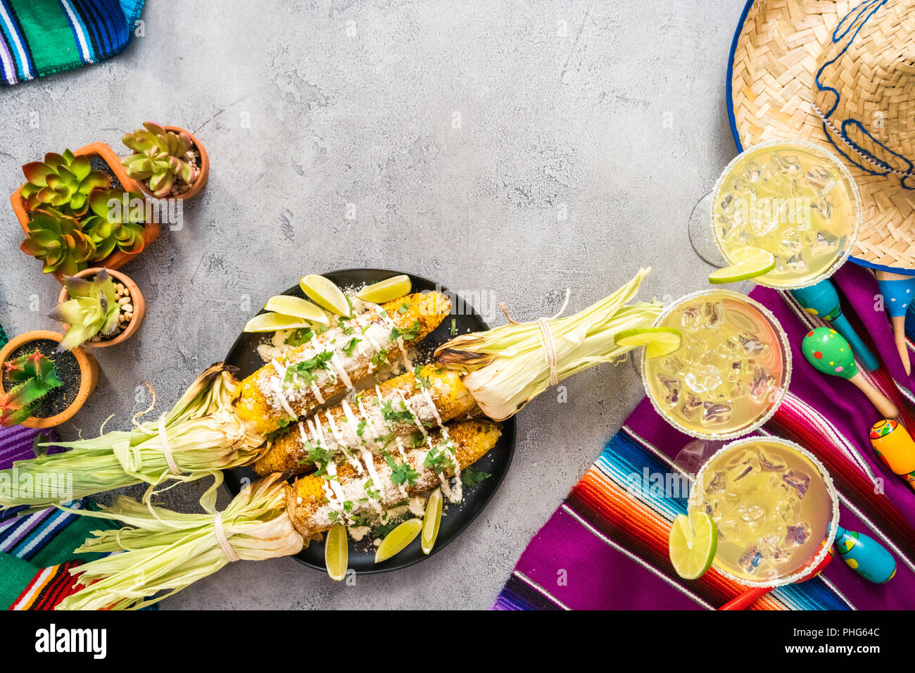 Top view. Grilling mexican street corn elote garnished with spices on a ...