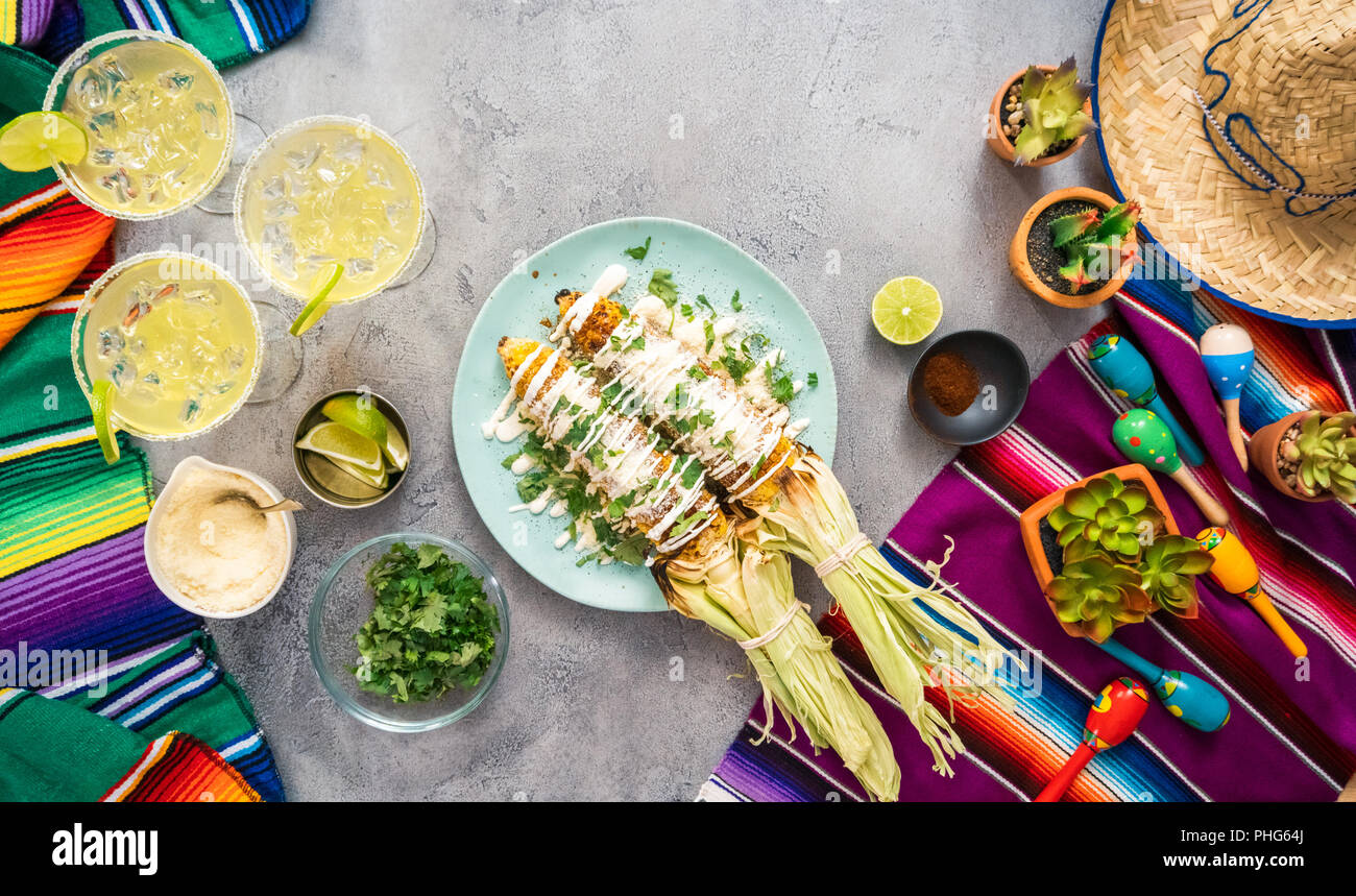 Top view. Grilling mexican street corn elote garnished with spices on a ...
