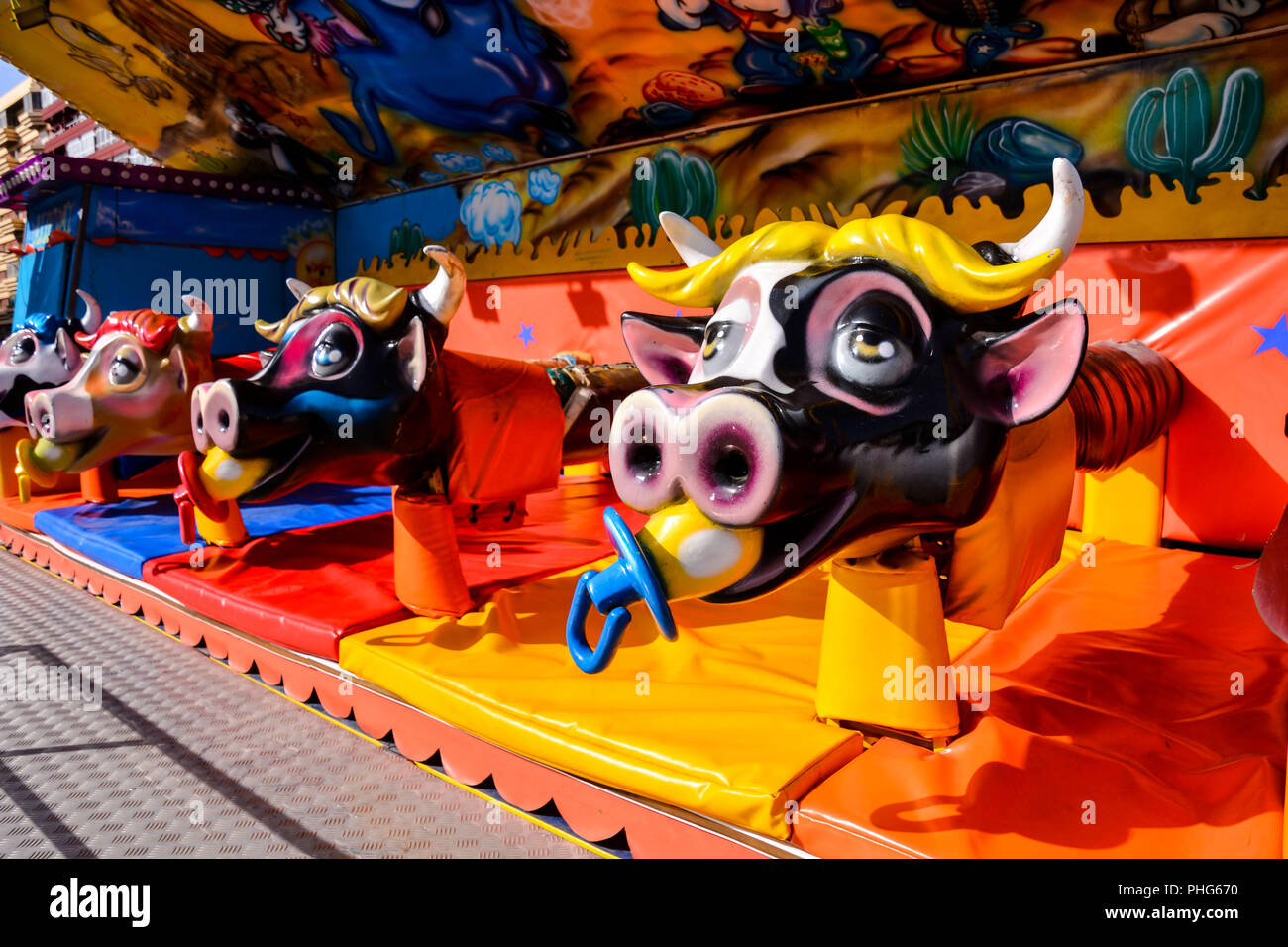 Outdoor vintage flying cow carousel Stock Photo - Alamy