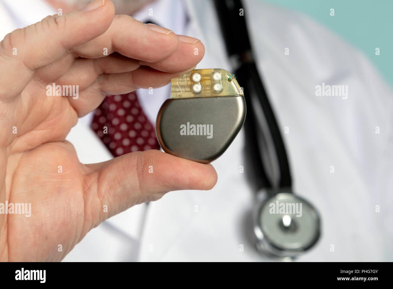 Male Hand hold Pacemaker in front of camera with blue background Stock ...