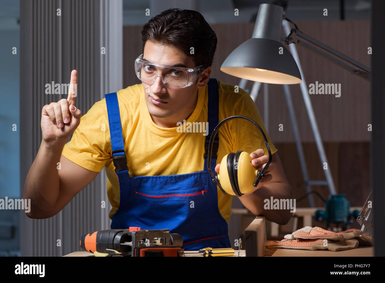 Worker working in repair workshop in woodworking concept Stock Photo ...