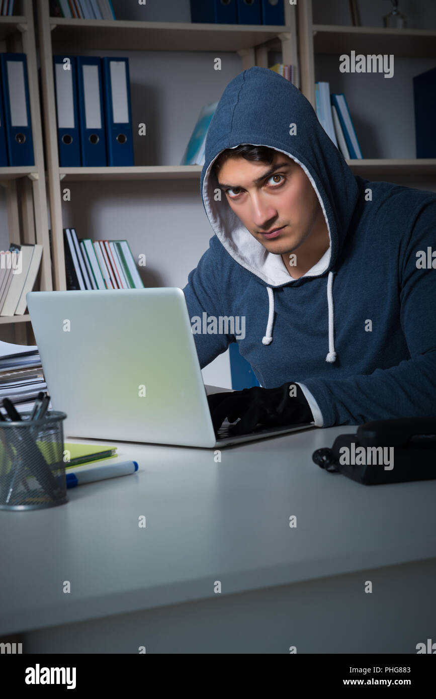 Young hacker hacking into computer at night Stock Photo - Alamy