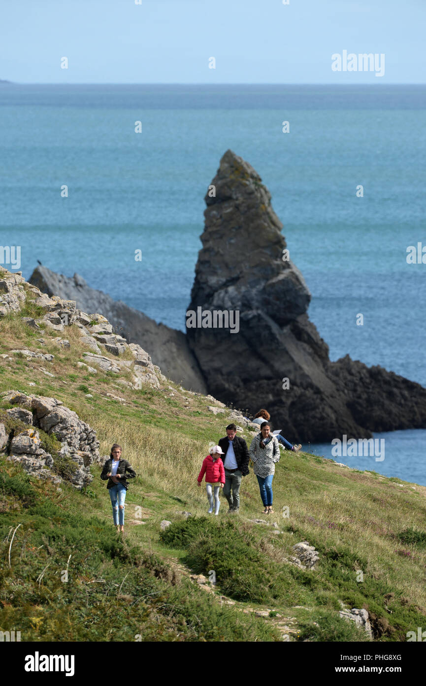 Family group walk the coast path near Church Rock, Broad Haven ...
