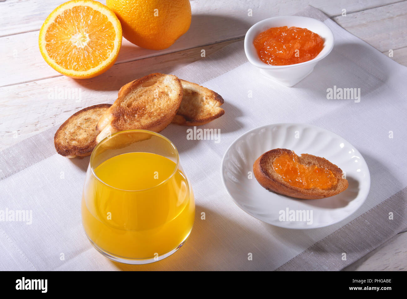 Morning Breakfast set with orange jam on bread toast and juice in glass ...