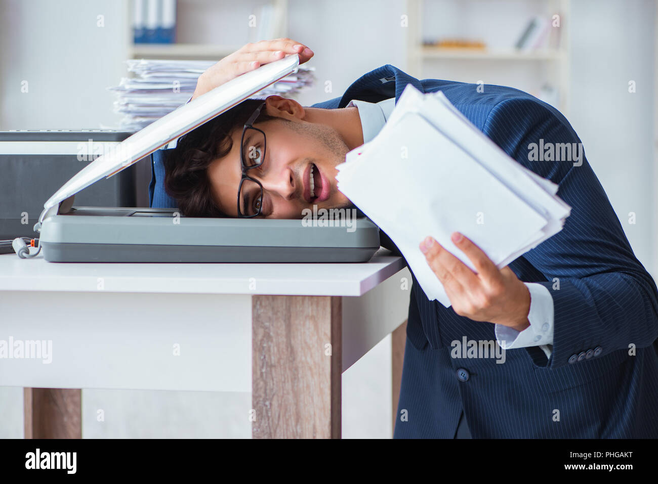 Businessman making copies in copying machine Stock Photo - Alamy