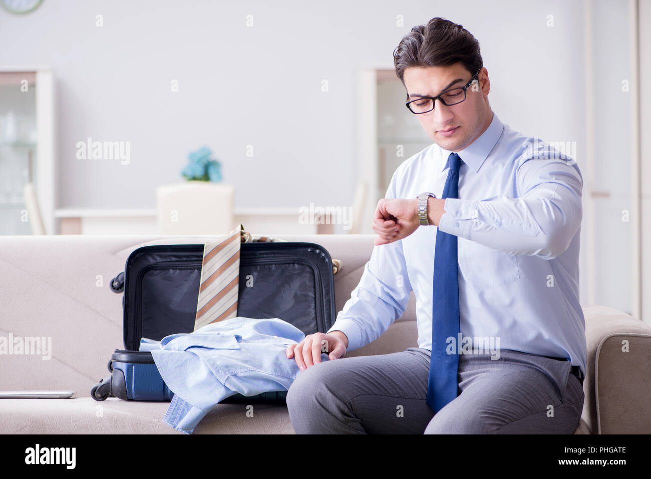 Businessman preparing packing for business trip Stock Photo - Alamy