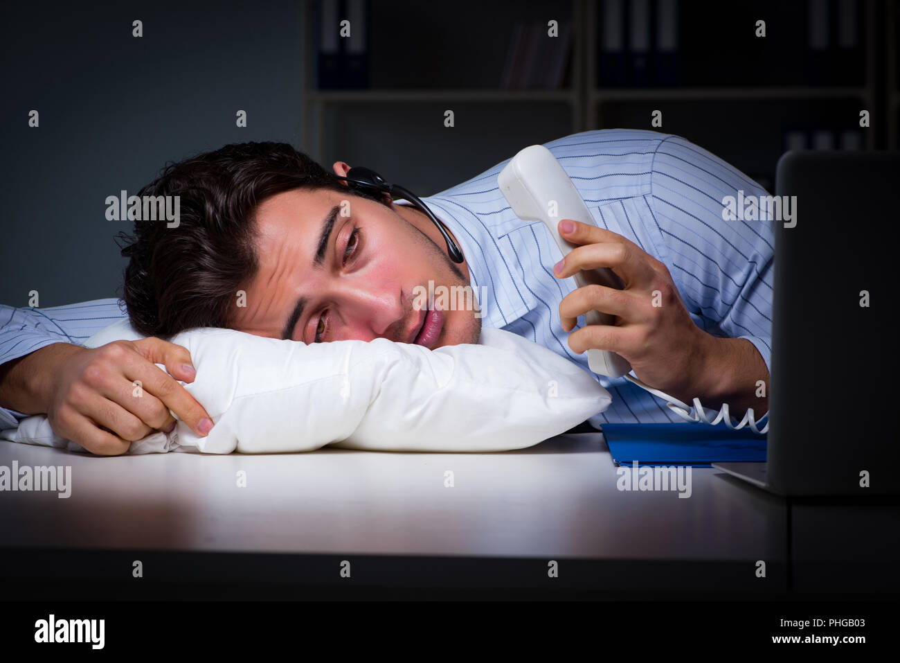 Tired and exhausted helpdesk operator during night shift Stock Photo ...