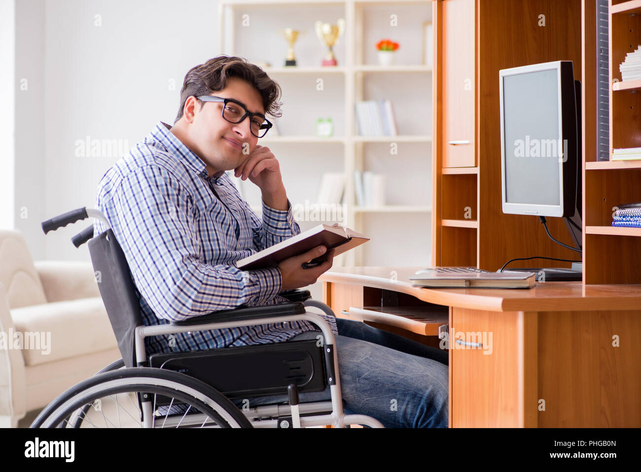 Disabled student studying at home on wheelchair Stock Photo - Alamy