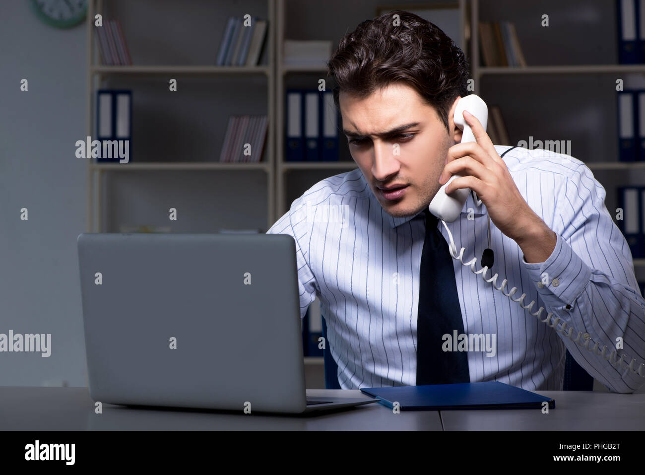 Tired and exhausted helpdesk operator during night shift Stock Photo ...