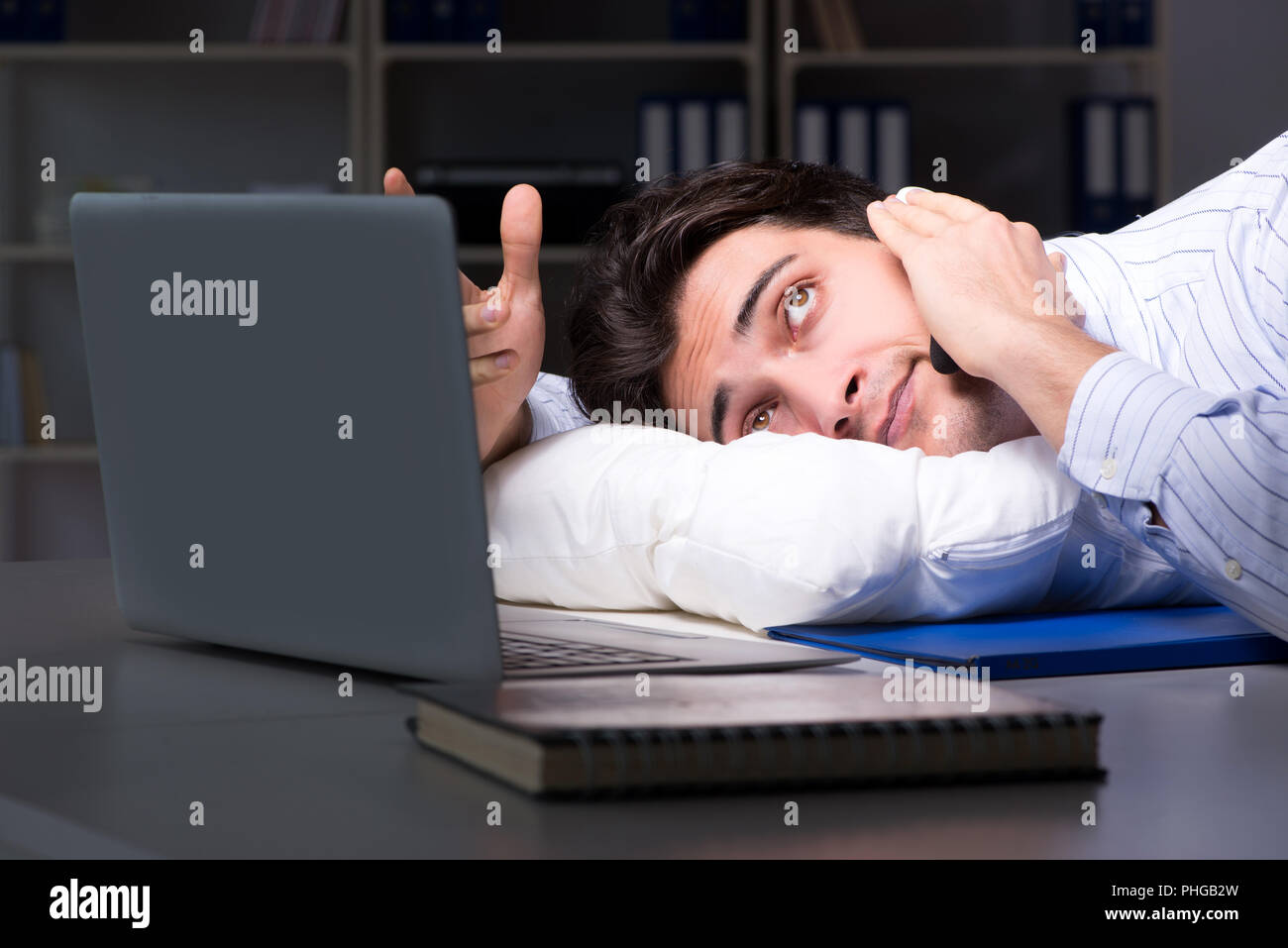 Tired and exhausted helpdesk operator during night shift Stock Photo ...
